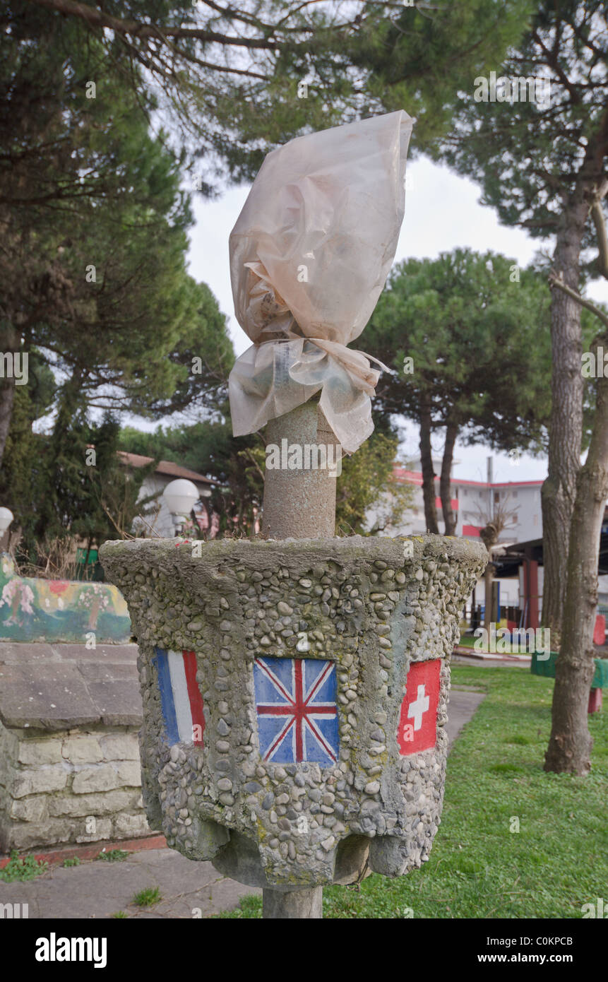 plant wrapped in plastic in tacky European flower pot Stock Photo - Alamy
