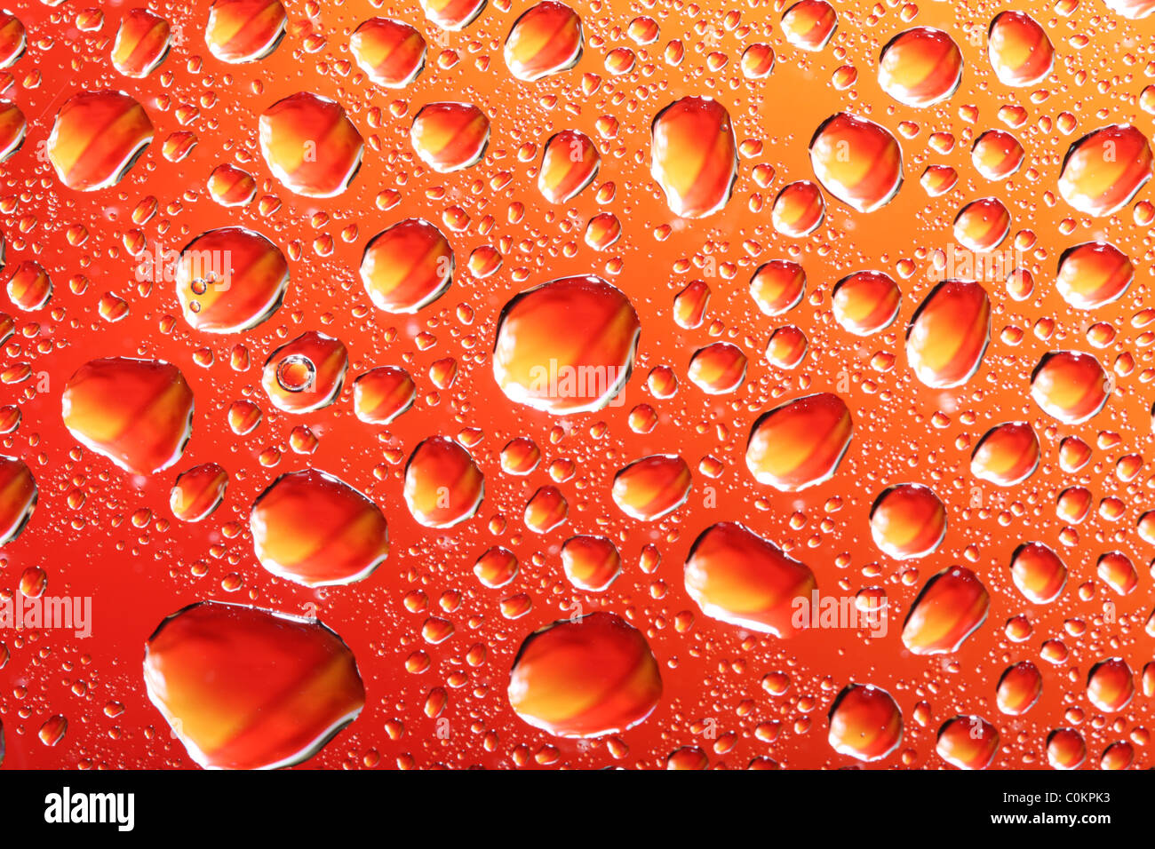 Orange water drops background Stock Photo - Alamy