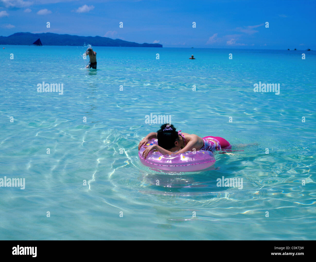Asian tourists playing in the ocean at White Beach, Boracay Island, the ...