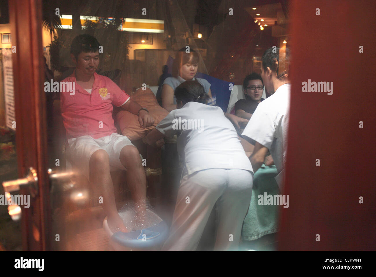 Asian tourists enjoy a foot massage on October 3, 2008 in Boracay ...