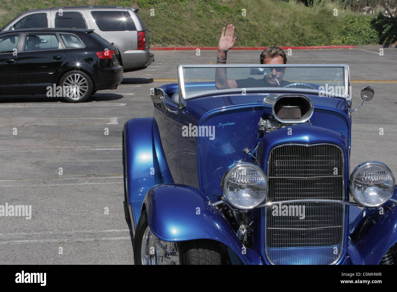 Johnny Hallyday in his hot rod car after lunching at Cafe Med in Sunset ...