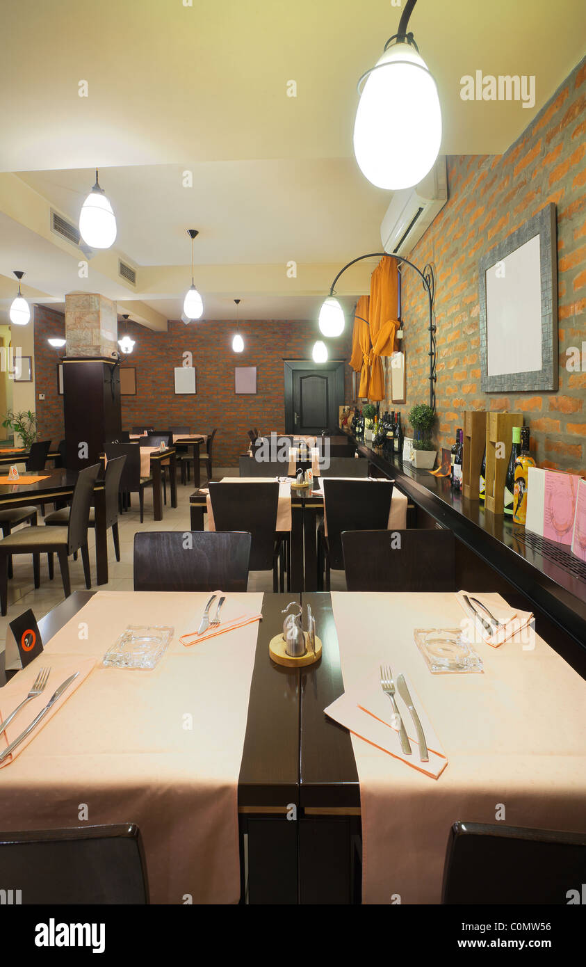 Tables, chairs and brick wall, interior of a restaurant Stock Photo - Alamy