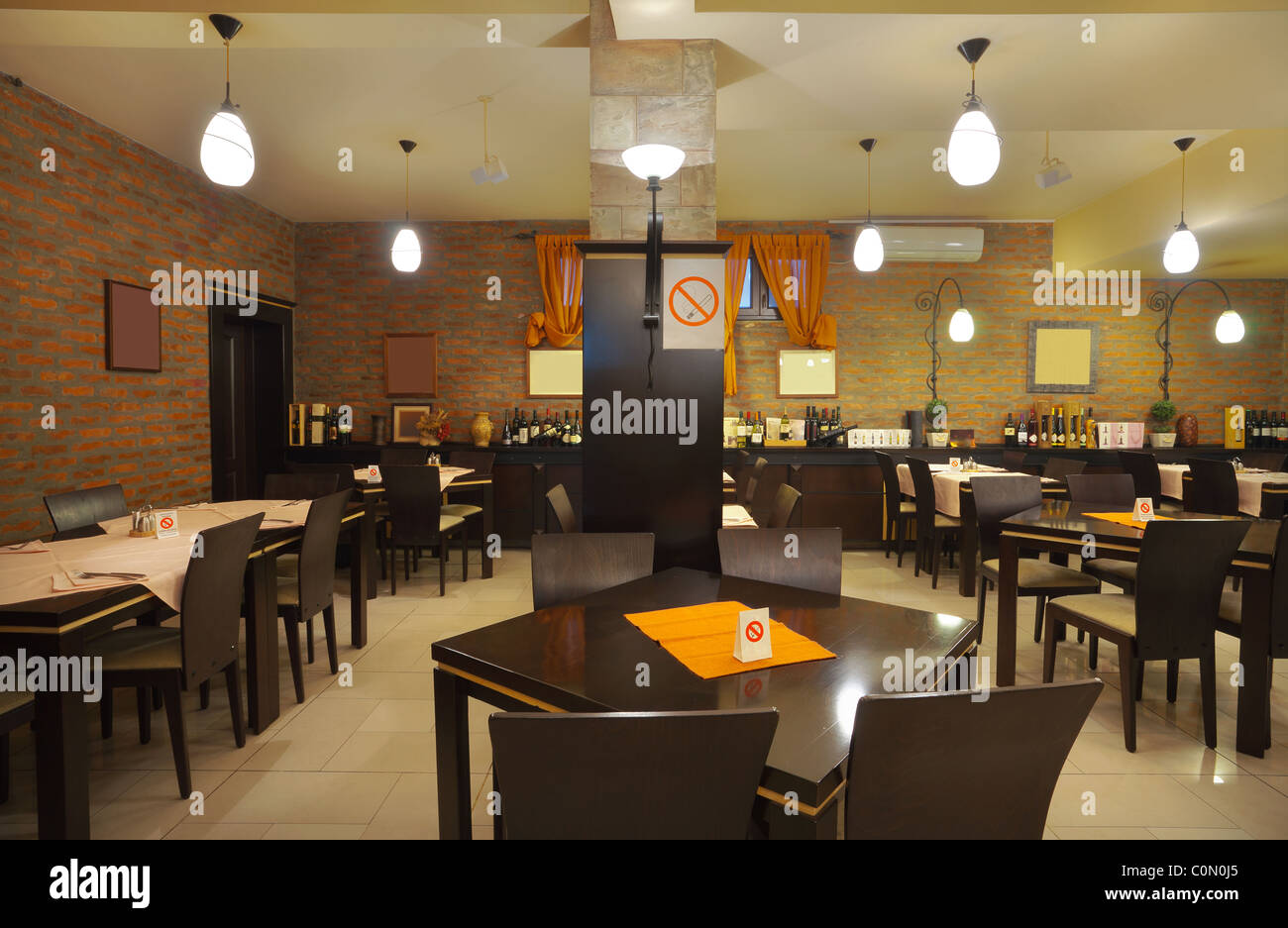 Tables, chairs and brick wall, interior of a restaurant Stock Photo - Alamy