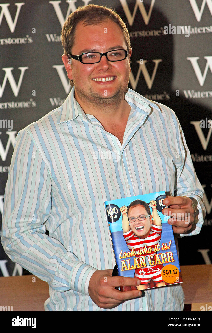 Comedian Alan Carr from "the Friday Night Project" signs copies of his ...