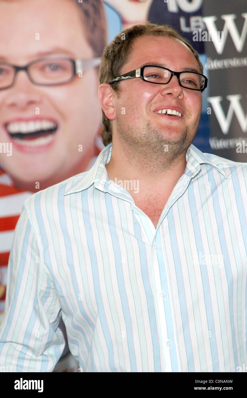 Comedian Alan Carr from "the Friday Night Project" signs copies of his ...