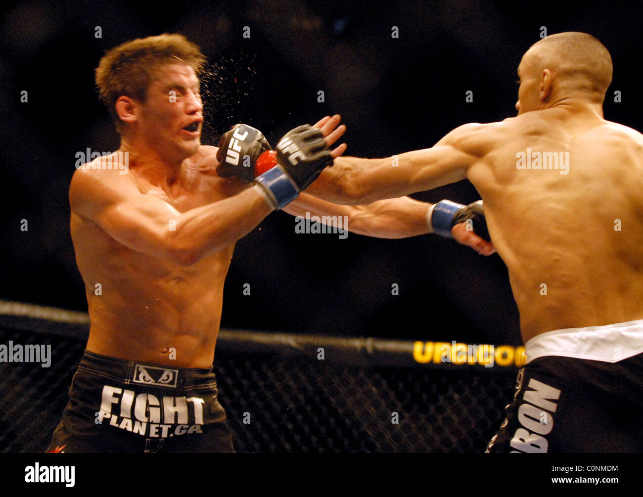 Fighters Terry Etim from Liverpool, England fights Sam Stout (with long ...