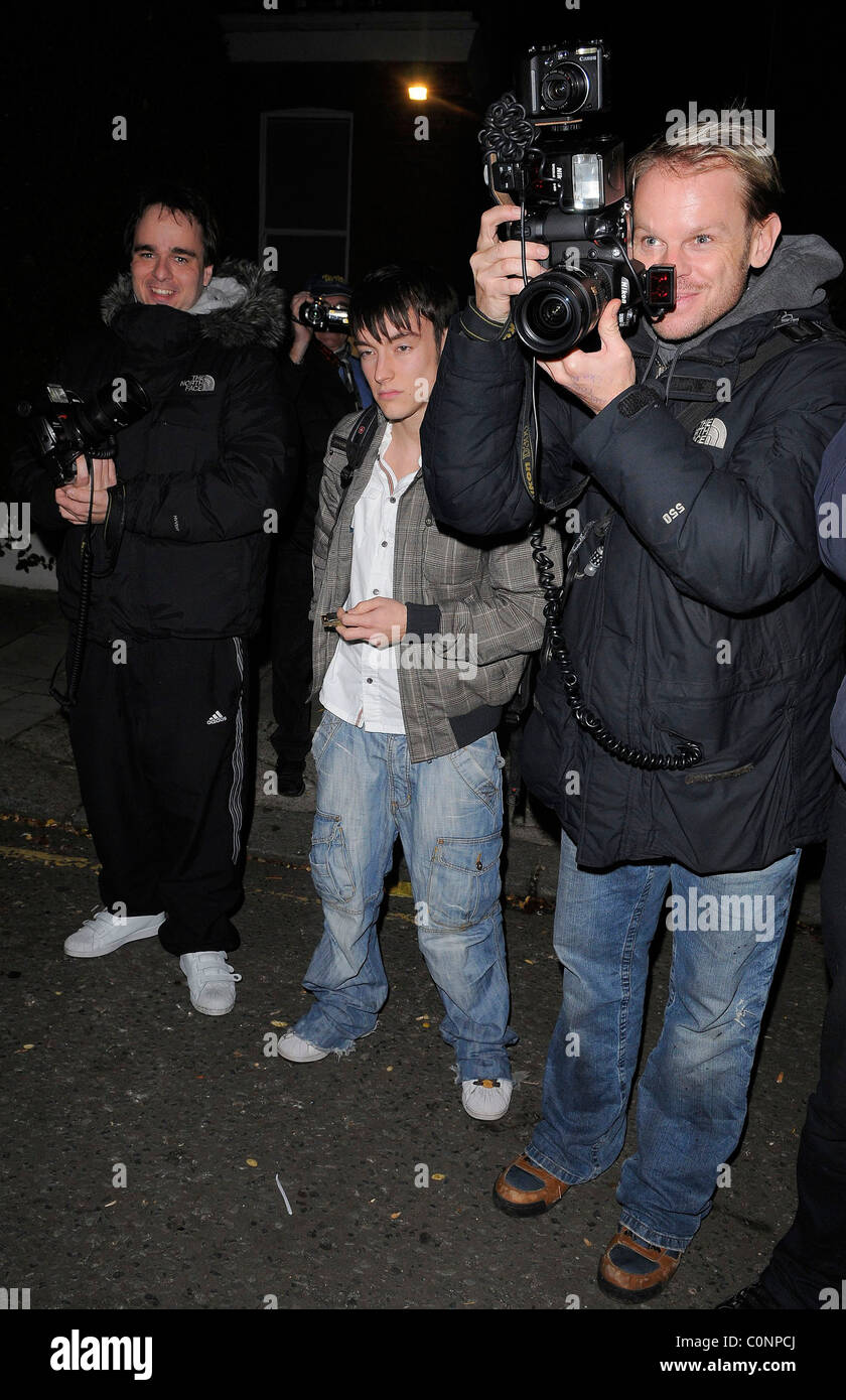 Austin Drage stands with photographers, as they take pictures of fellow ...