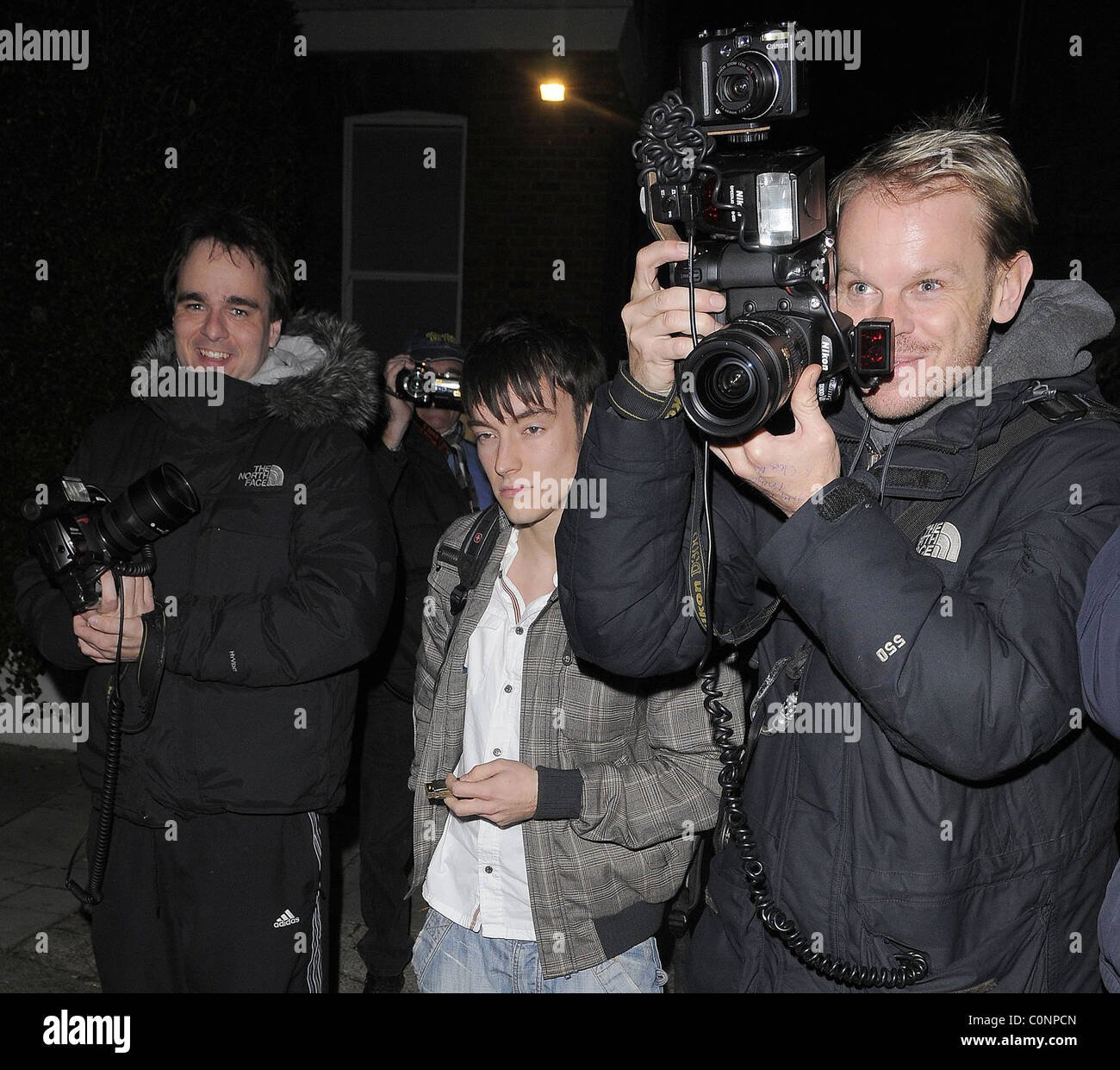 Austin Drage stands with photographers, as they take pictures of fellow ...