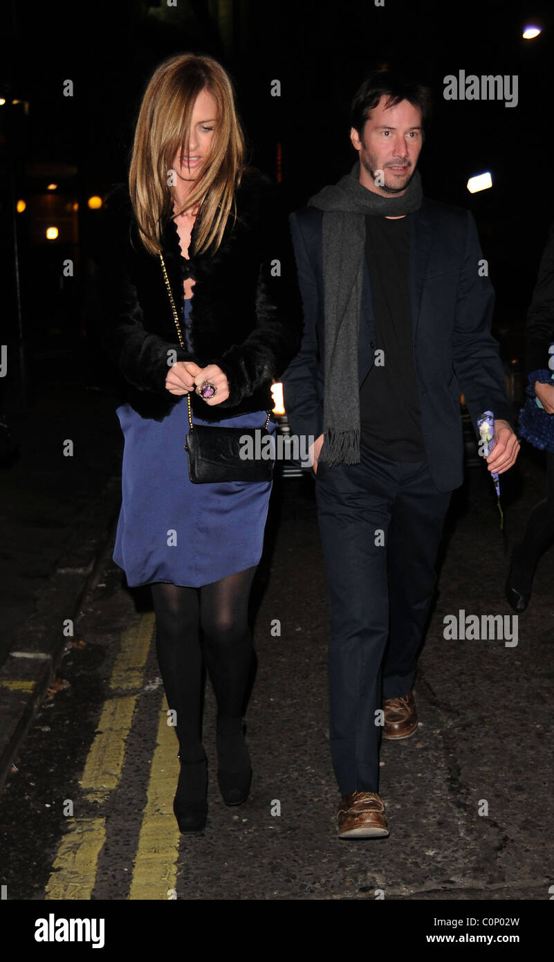 Keanu Reeves holding a single white rose arrives at the Ivy with Trinny ...