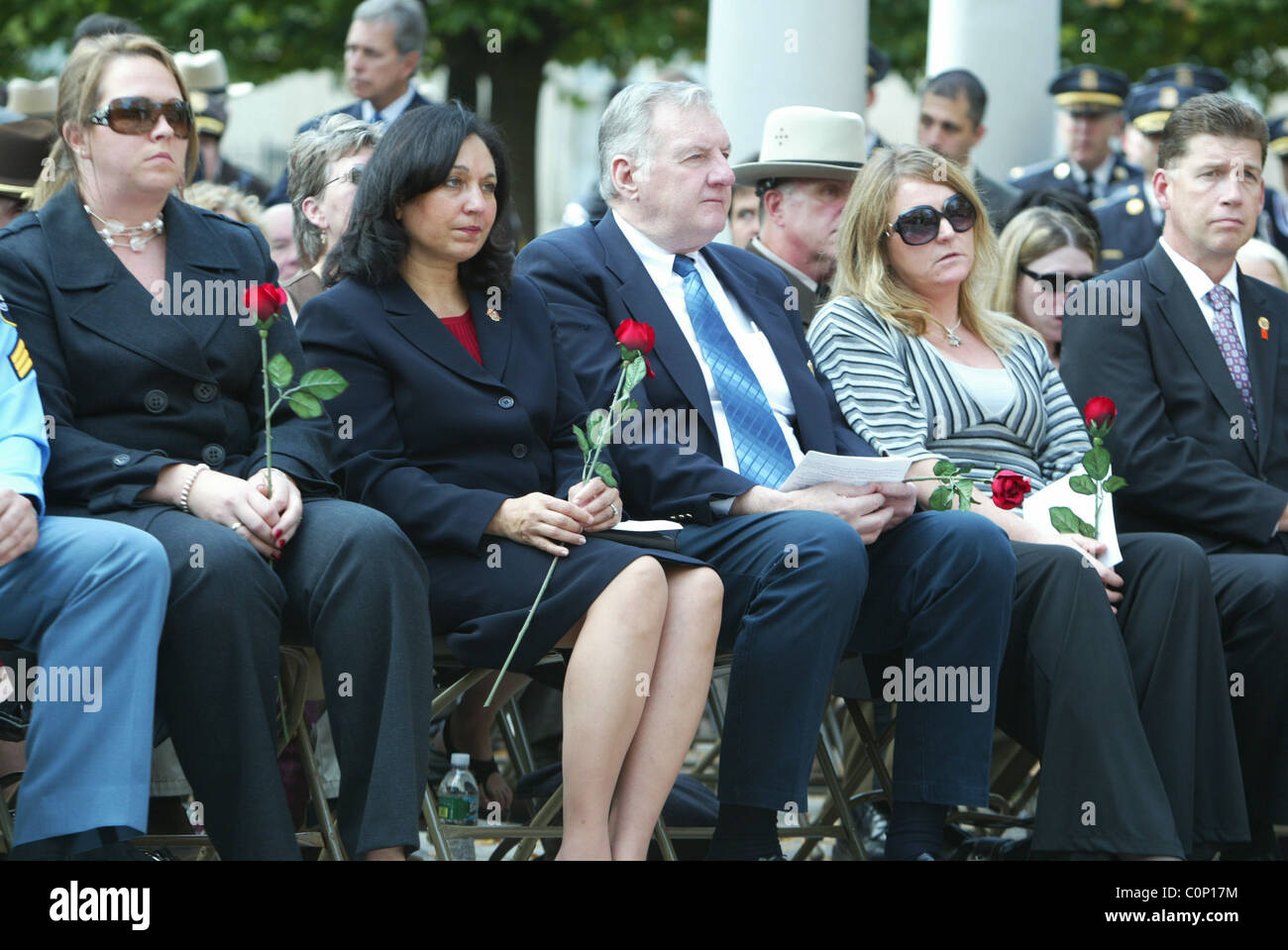 The bereaved hold their rose before placing on the National Law ...