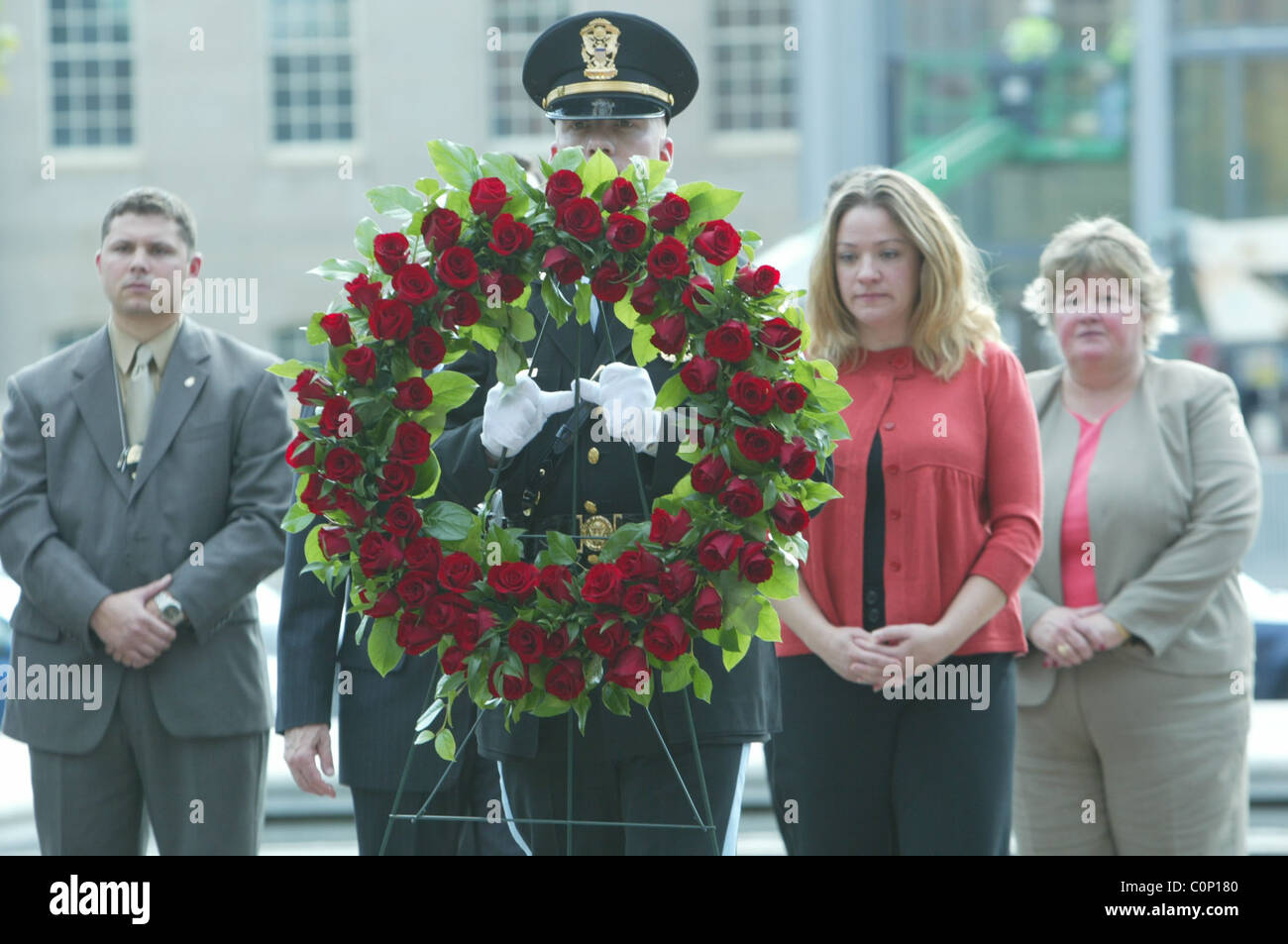 The bereaved hold their rose before placing on the National Law ...