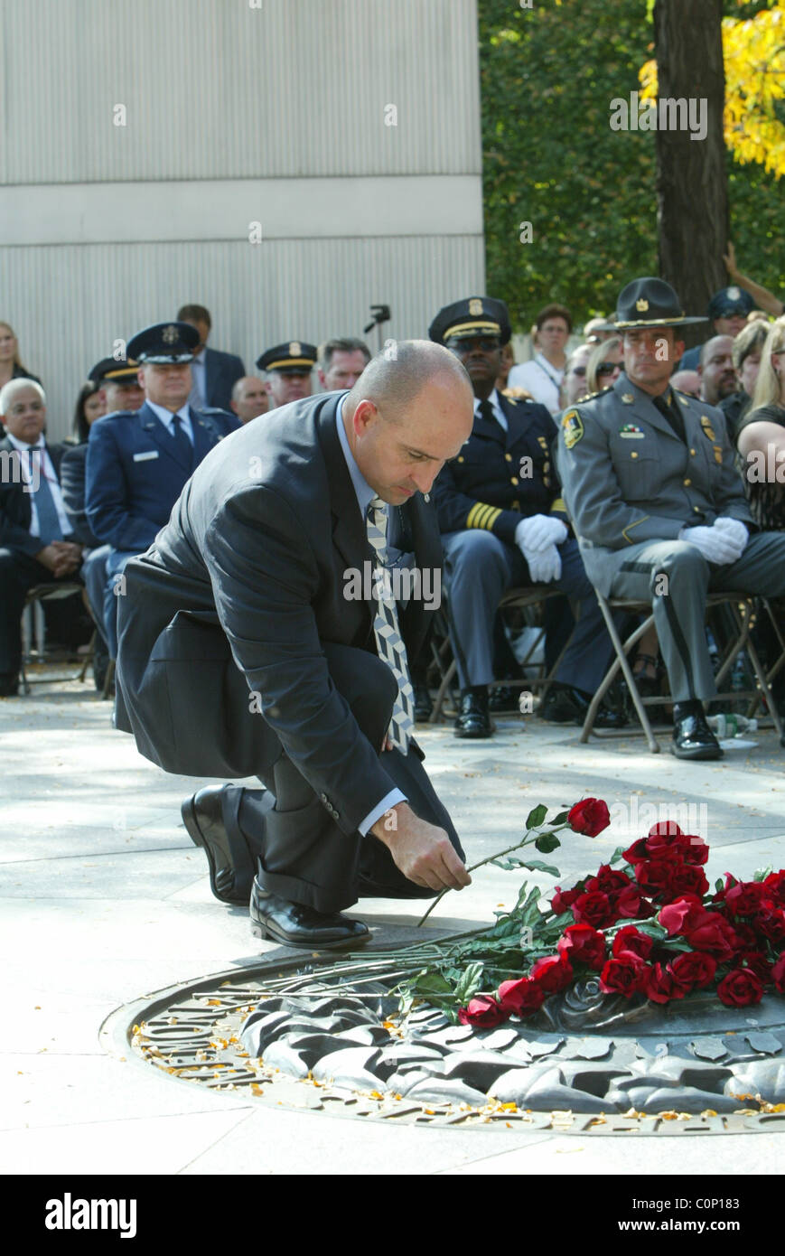 The bereaved hold their rose before placing on the National Law ...