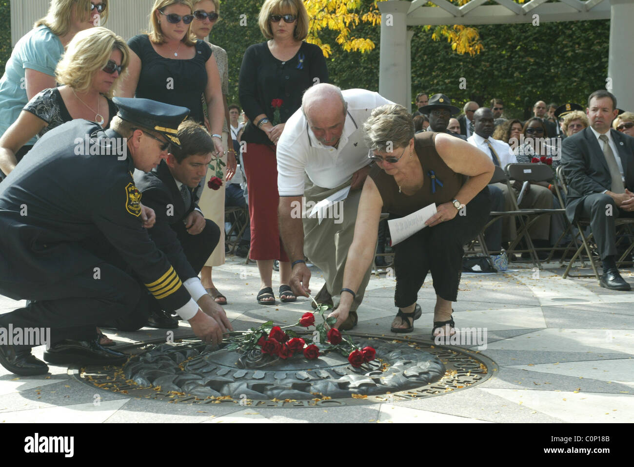 The bereaved hold their rose before placing on the National Law ...