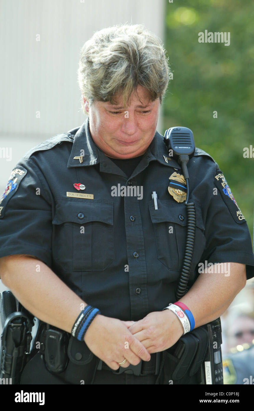 The bereaved hold their rose before placing on the National Law ...
