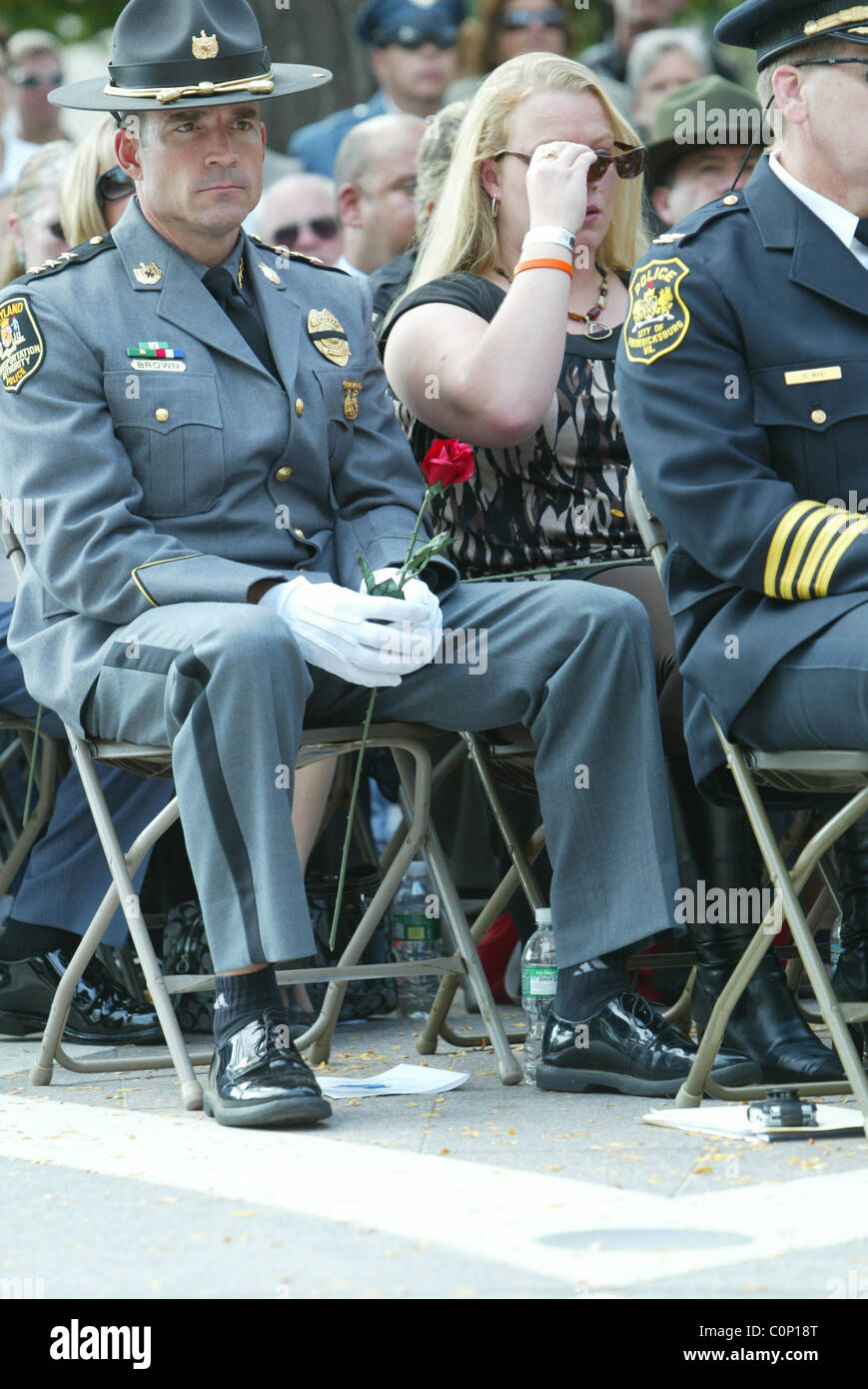 The bereaved hold their rose before placing on the National Law ...