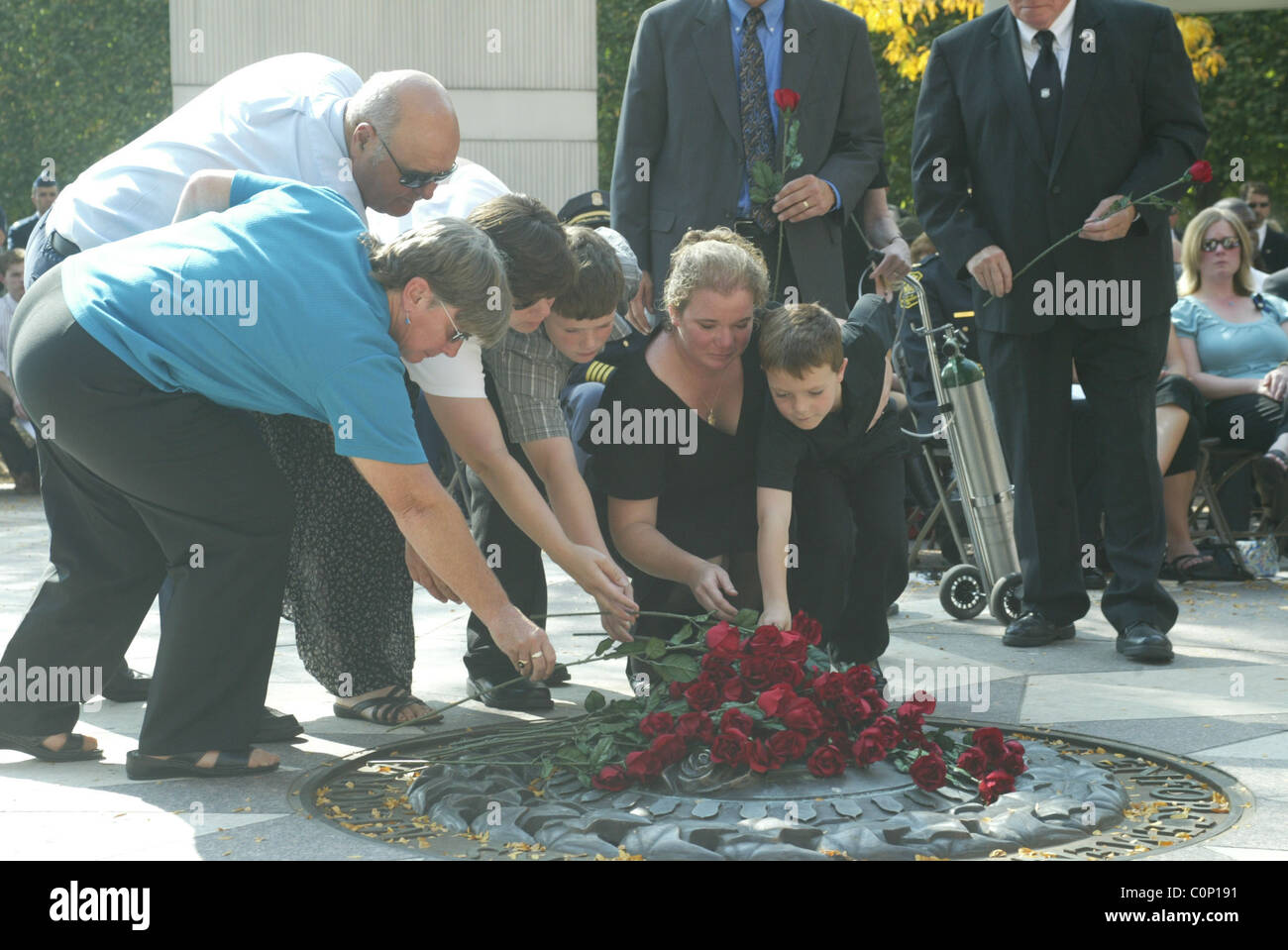 The bereaved hold their rose before placing on the National Law ...