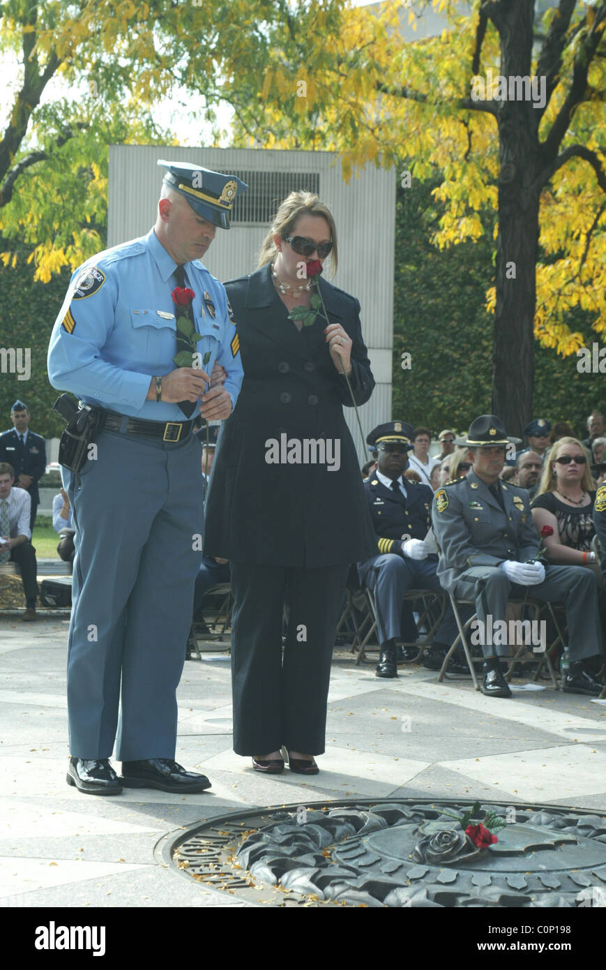 The bereaved hold their rose before placing on the National Law ...