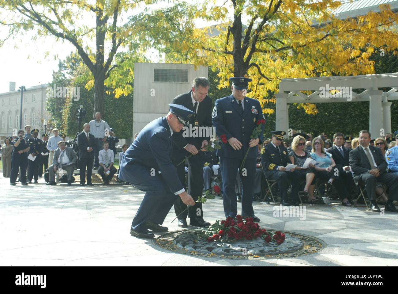 The bereaved hold their rose before placing on the National Law ...