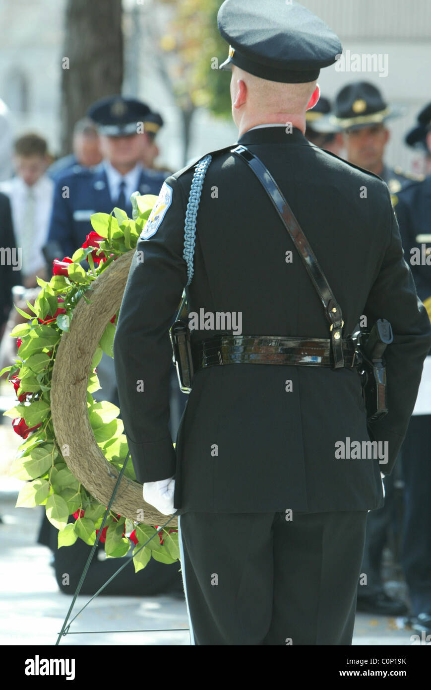 The bereaved hold their rose before placing on the National Law ...