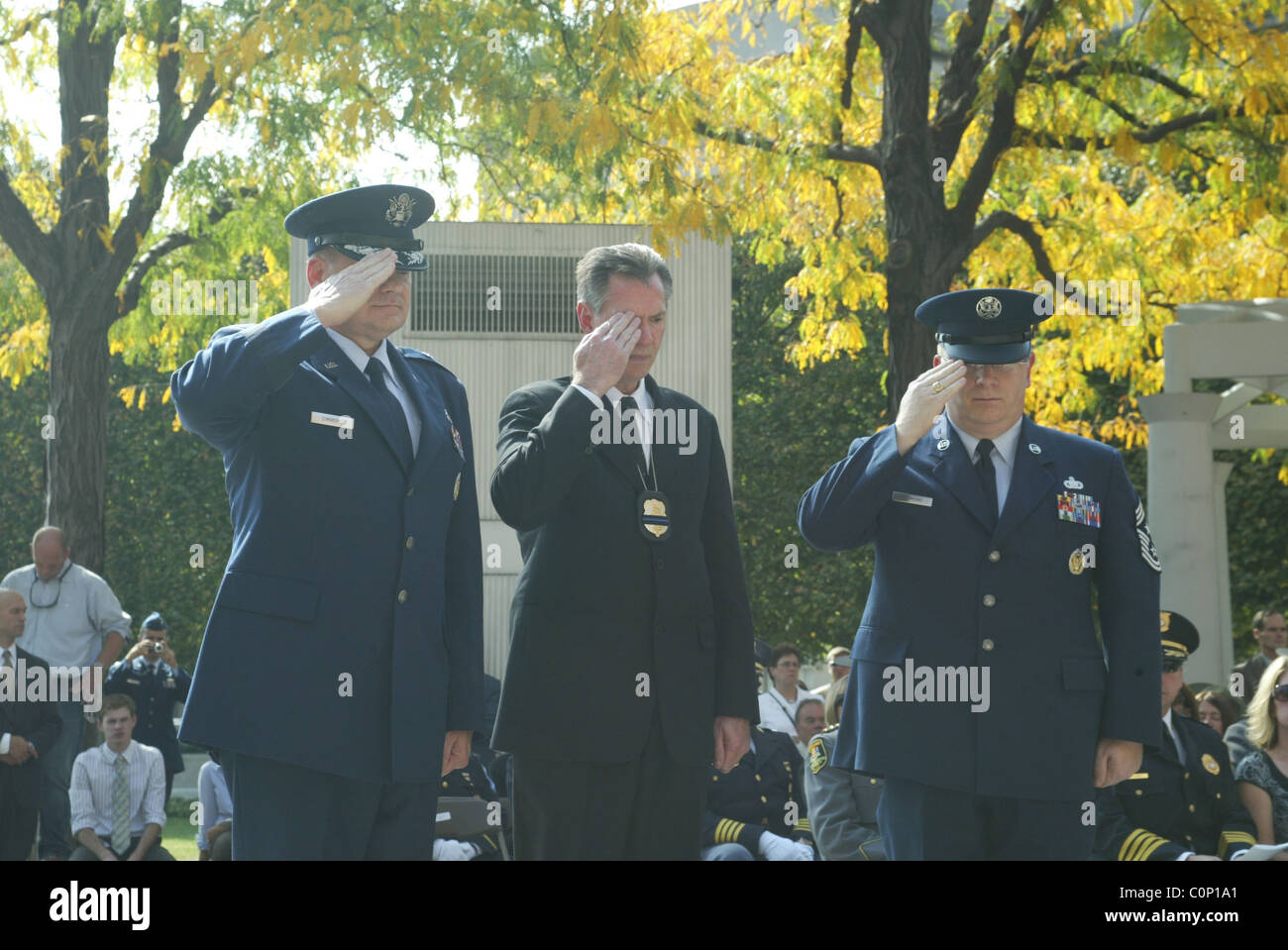 The bereaved hold their rose before placing on the National Law ...