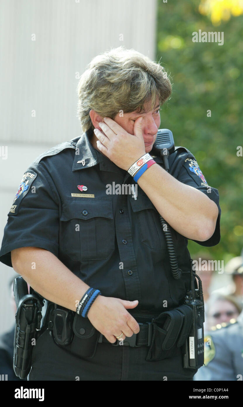 The bereaved hold their rose before placing on the National Law ...