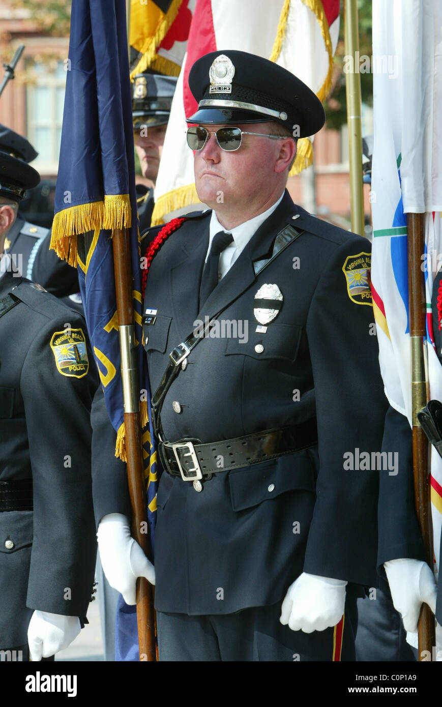 The bereaved hold their rose before placing on the National Law ...