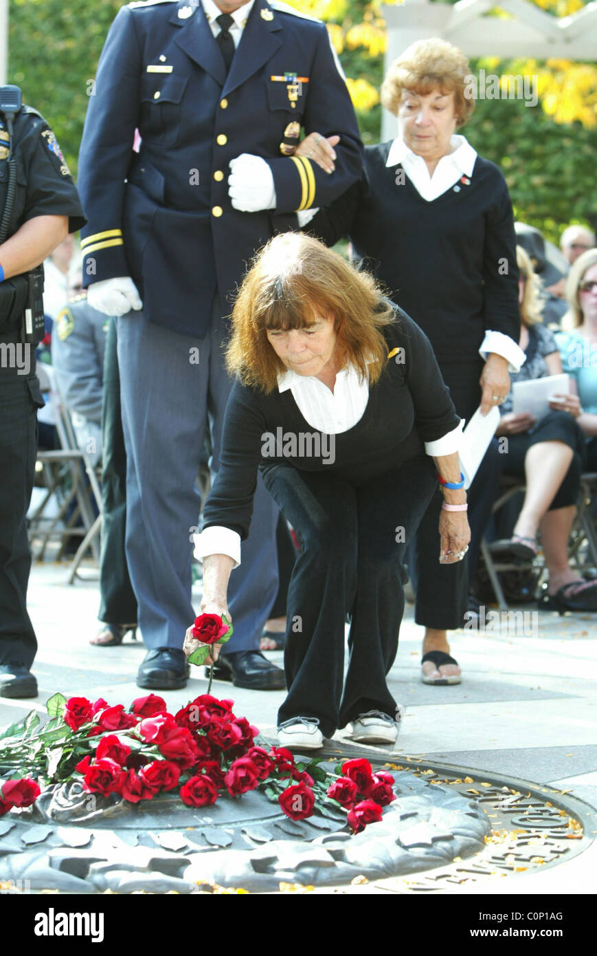 The bereaved hold their rose before placing on the National Law ...