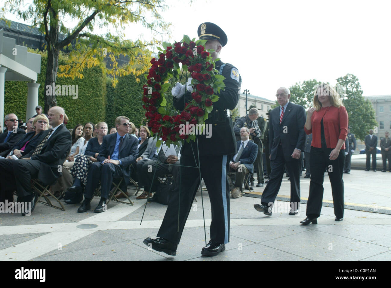 The bereaved hold their rose before placing on the National Law ...