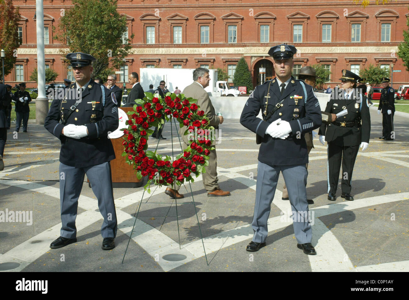 The bereaved hold their rose before placing on the National Law ...