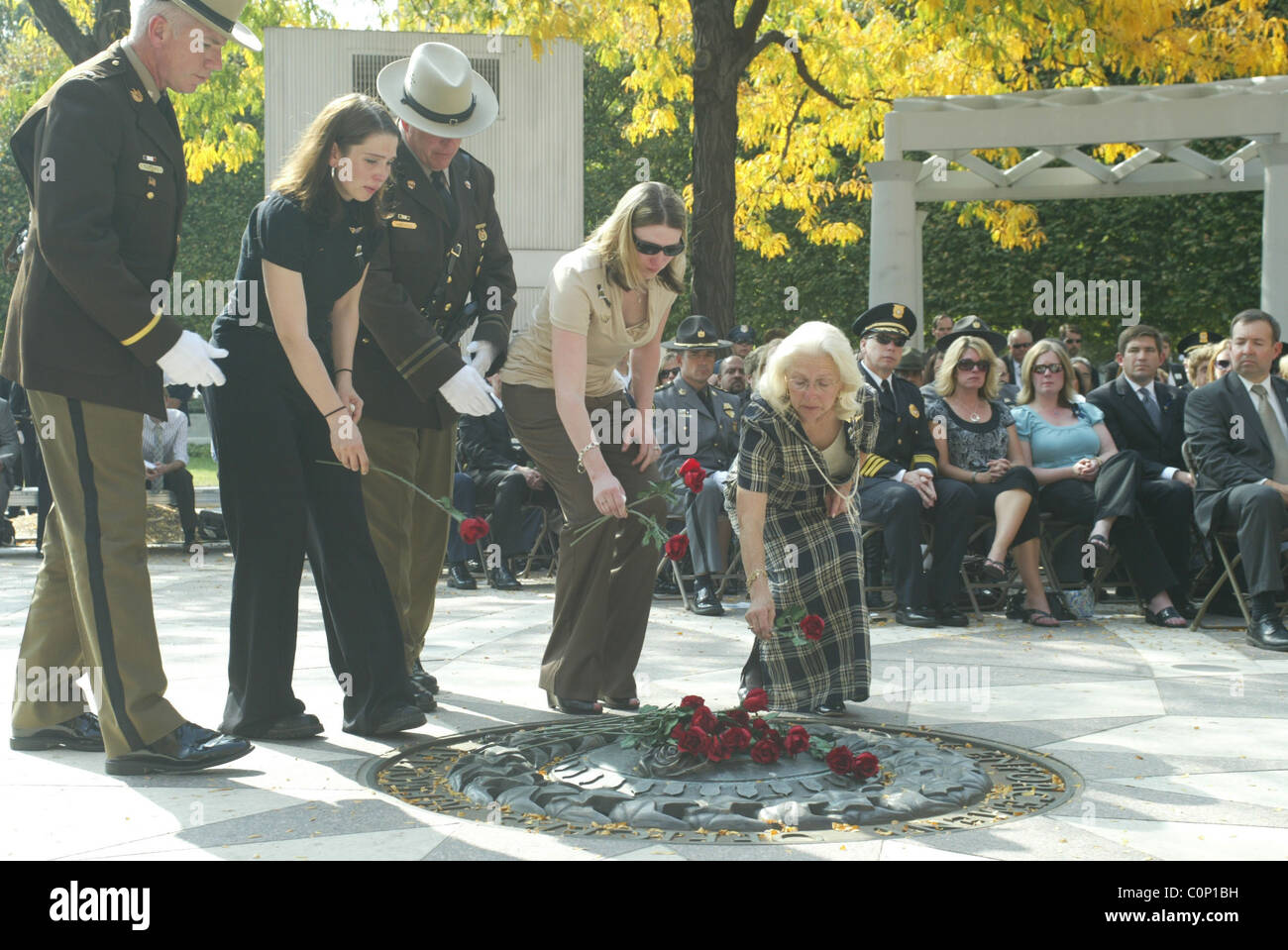 The bereaved hold their rose before placing on the National Law ...