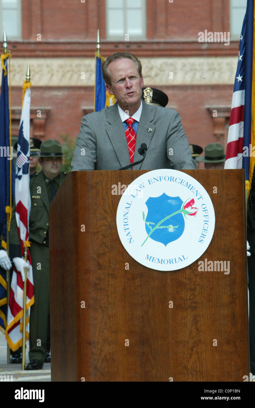 The bereaved hold their rose before placing on the National Law ...