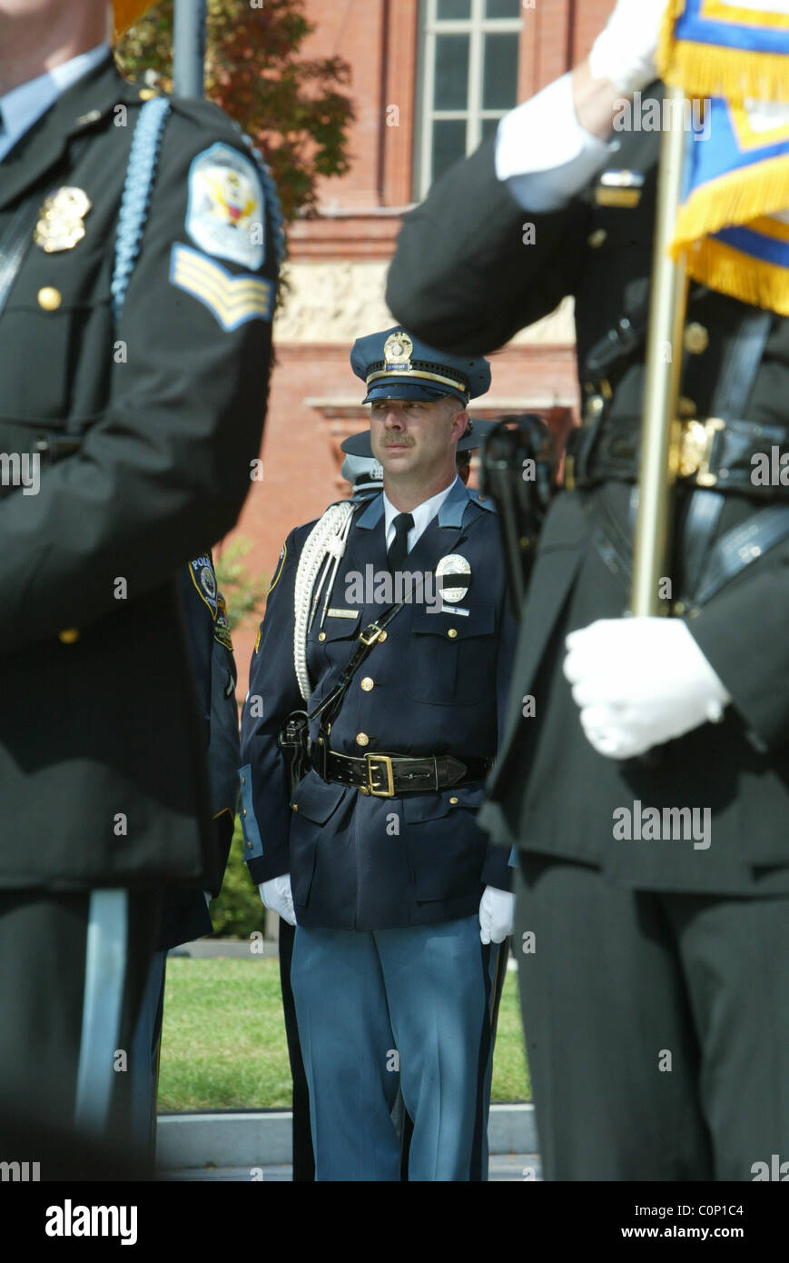 The bereaved hold their rose before placing on the National Law ...