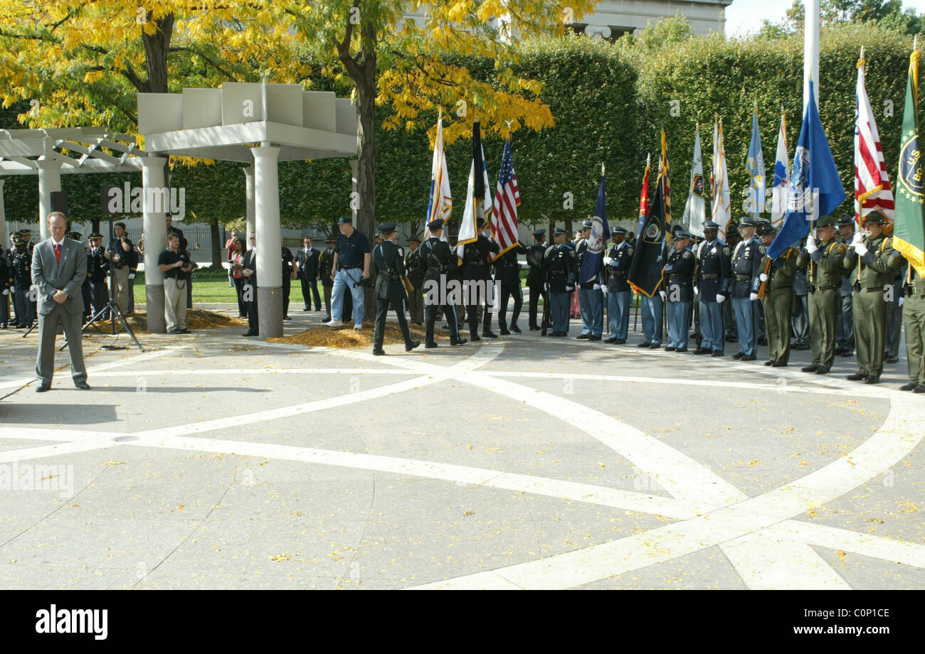 The bereaved hold their rose before placing on the National Law ...