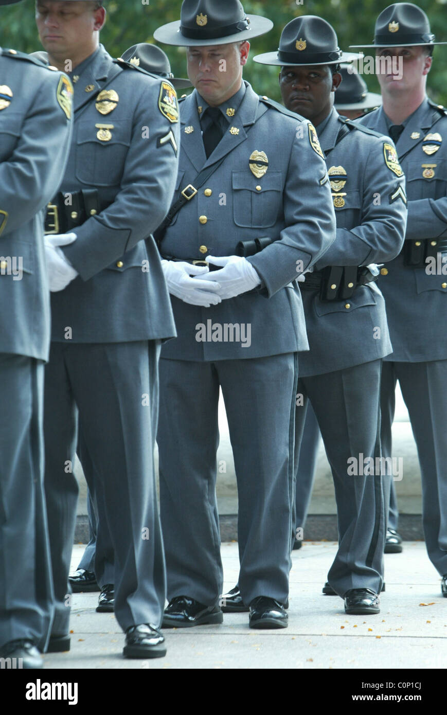 The bereaved hold their rose before placing on the National Law ...