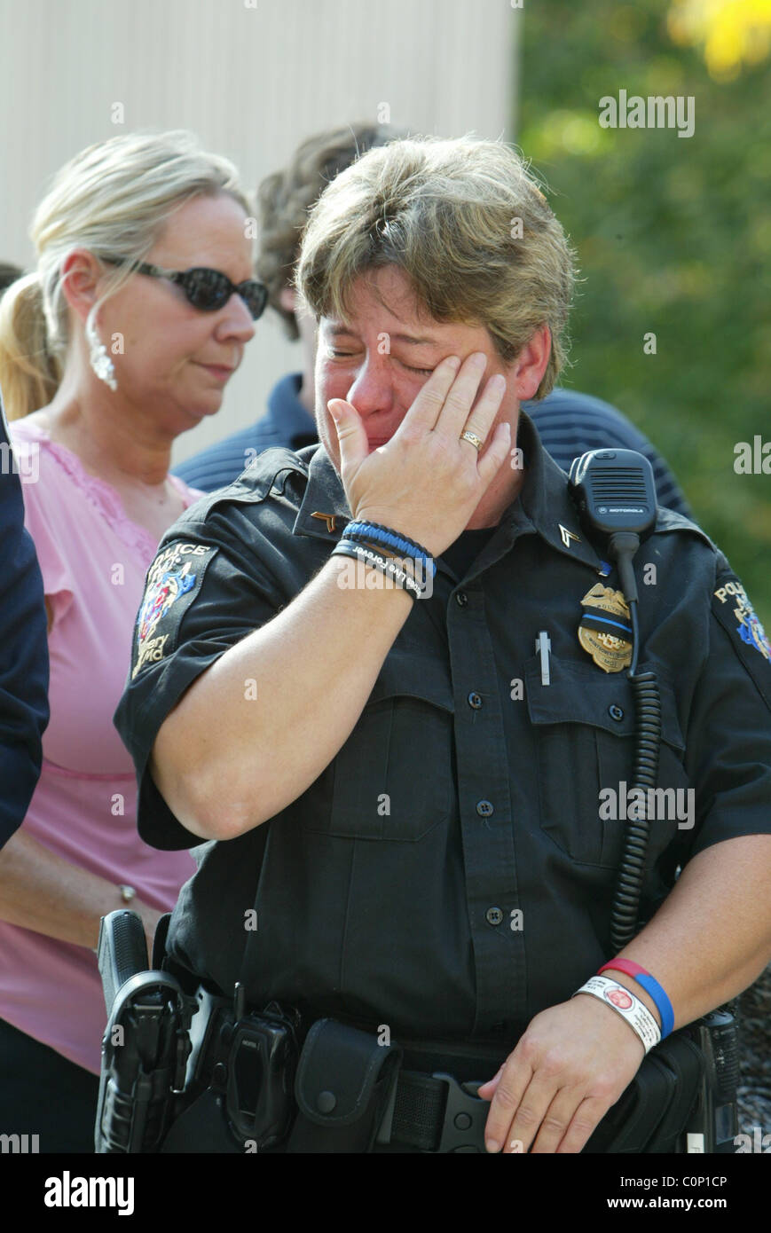 The bereaved hold their rose before placing on the National Law ...