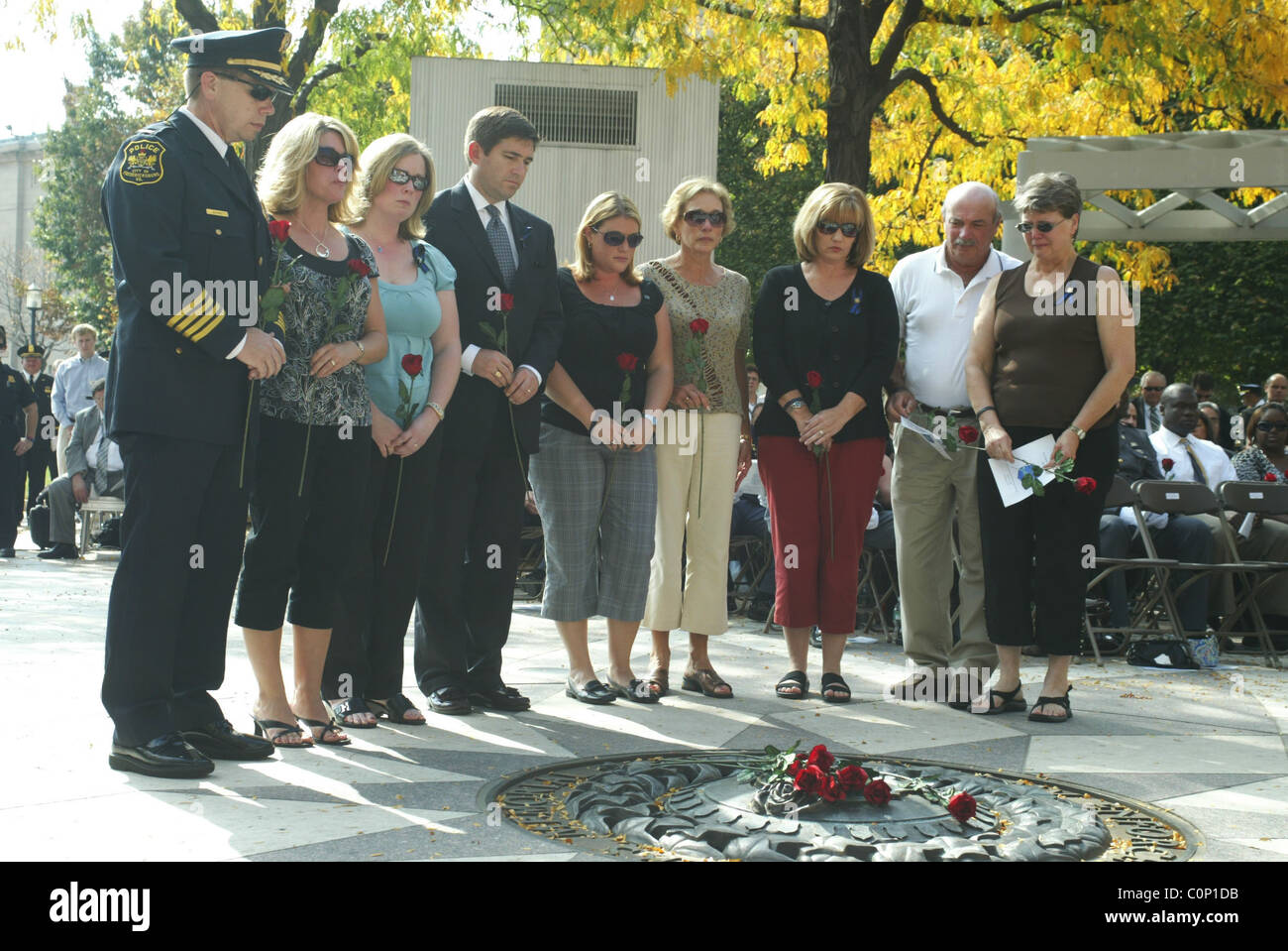 The bereaved hold their rose before placing on the National Law ...