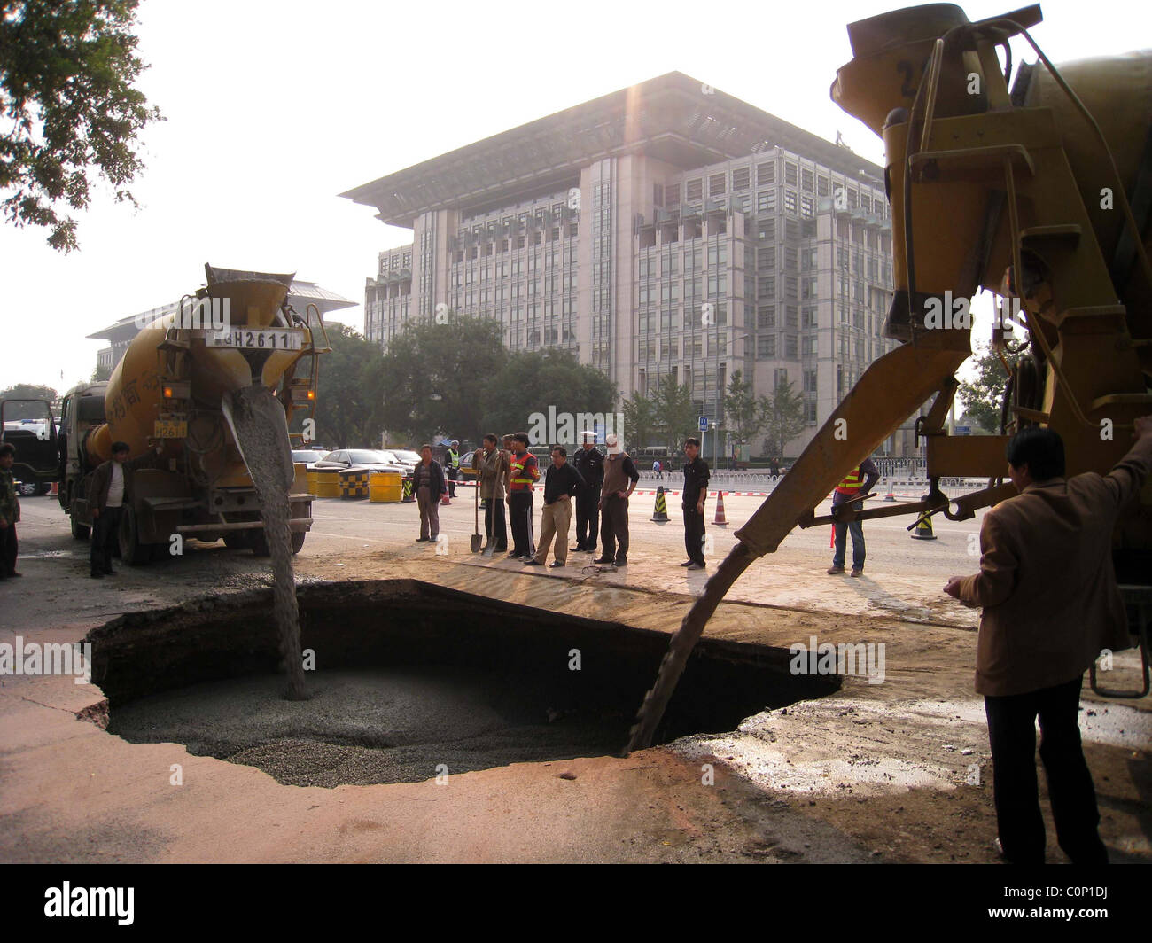 FIXING A HOLE... Construction workers acted quickly when an enormous ...