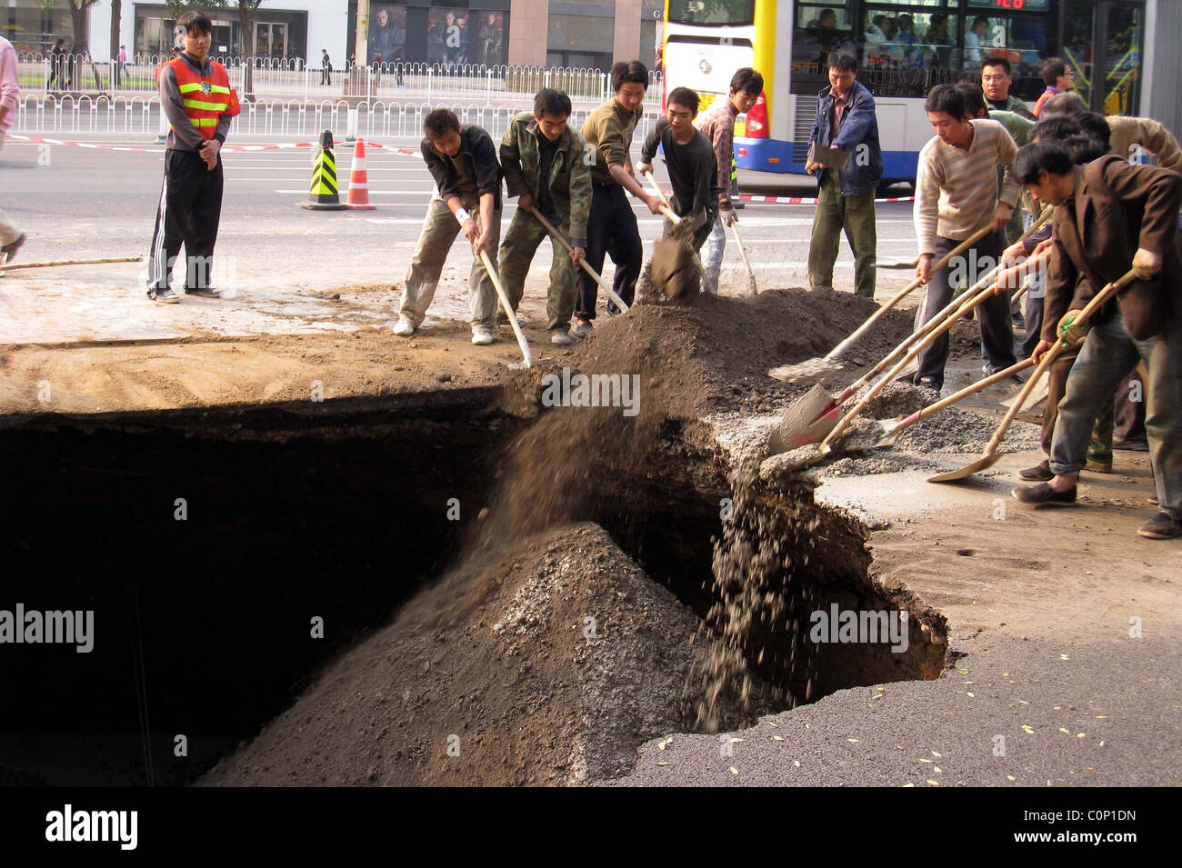 FIXING A HOLE... Construction workers acted quickly when an enormous ...