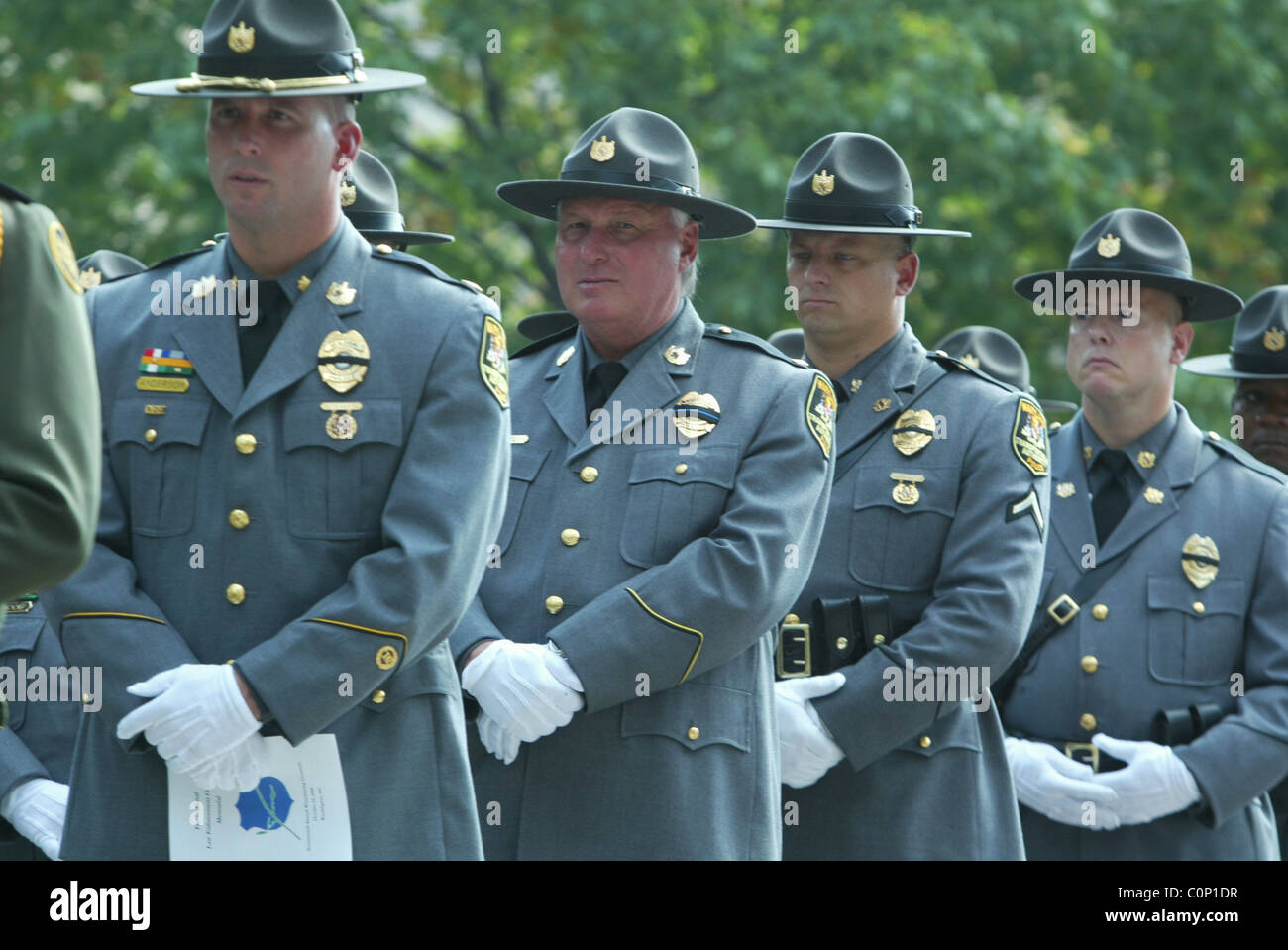 The bereaved hold their rose before placing on the National Law ...