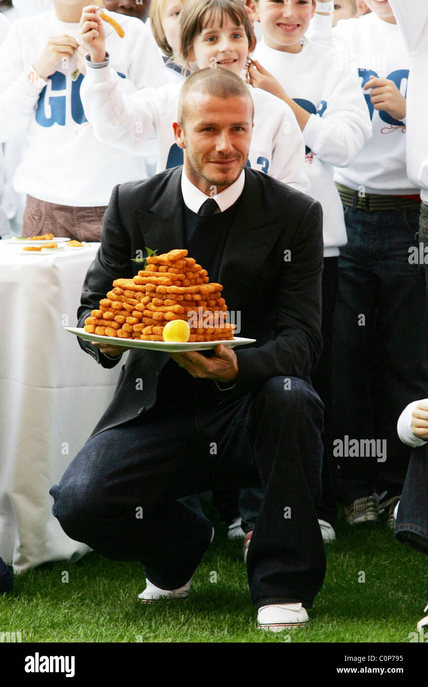 David Beckham poses with children as he launches the new GO3 food range ...
