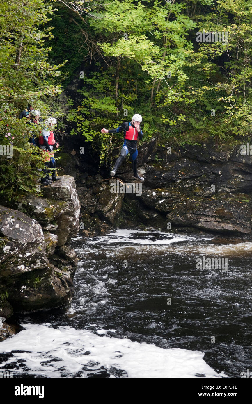 Gorge walking, also known as canyoning at the Falls of Falloch just off ...
