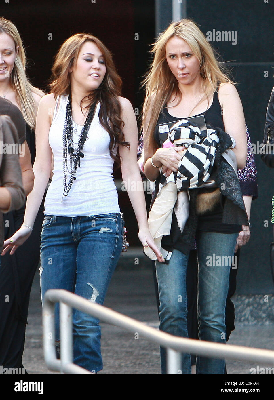 Miley Cyrus is in high spirits as she leaves a studio with her mother ...