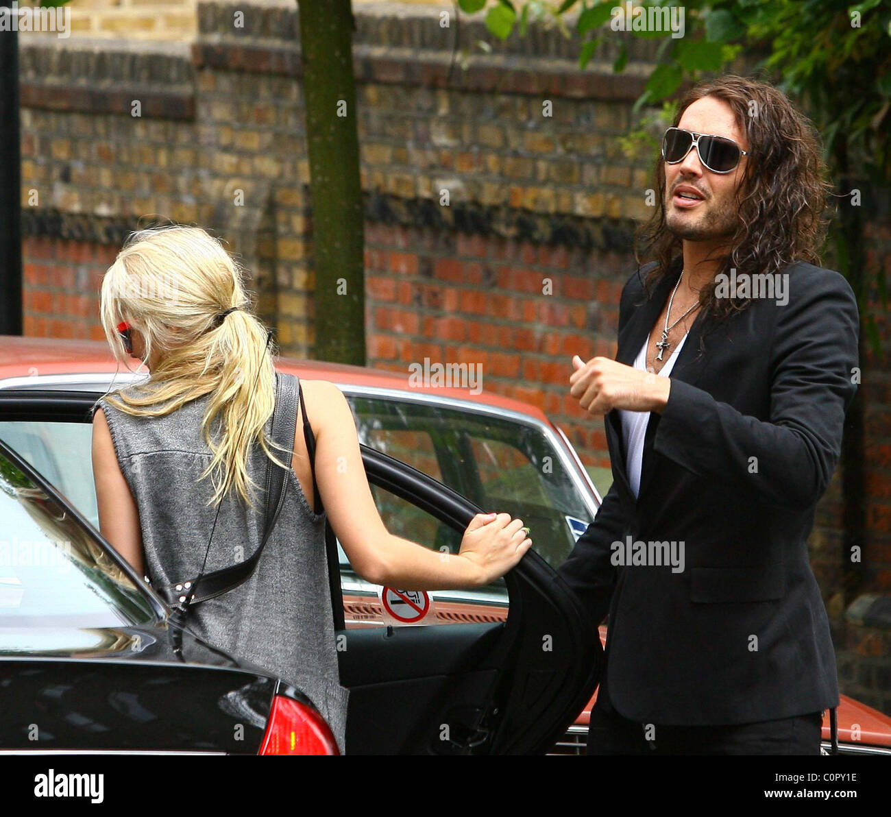 Russell Brand and his girlfriend Teresa Palmer leaving his London home ...