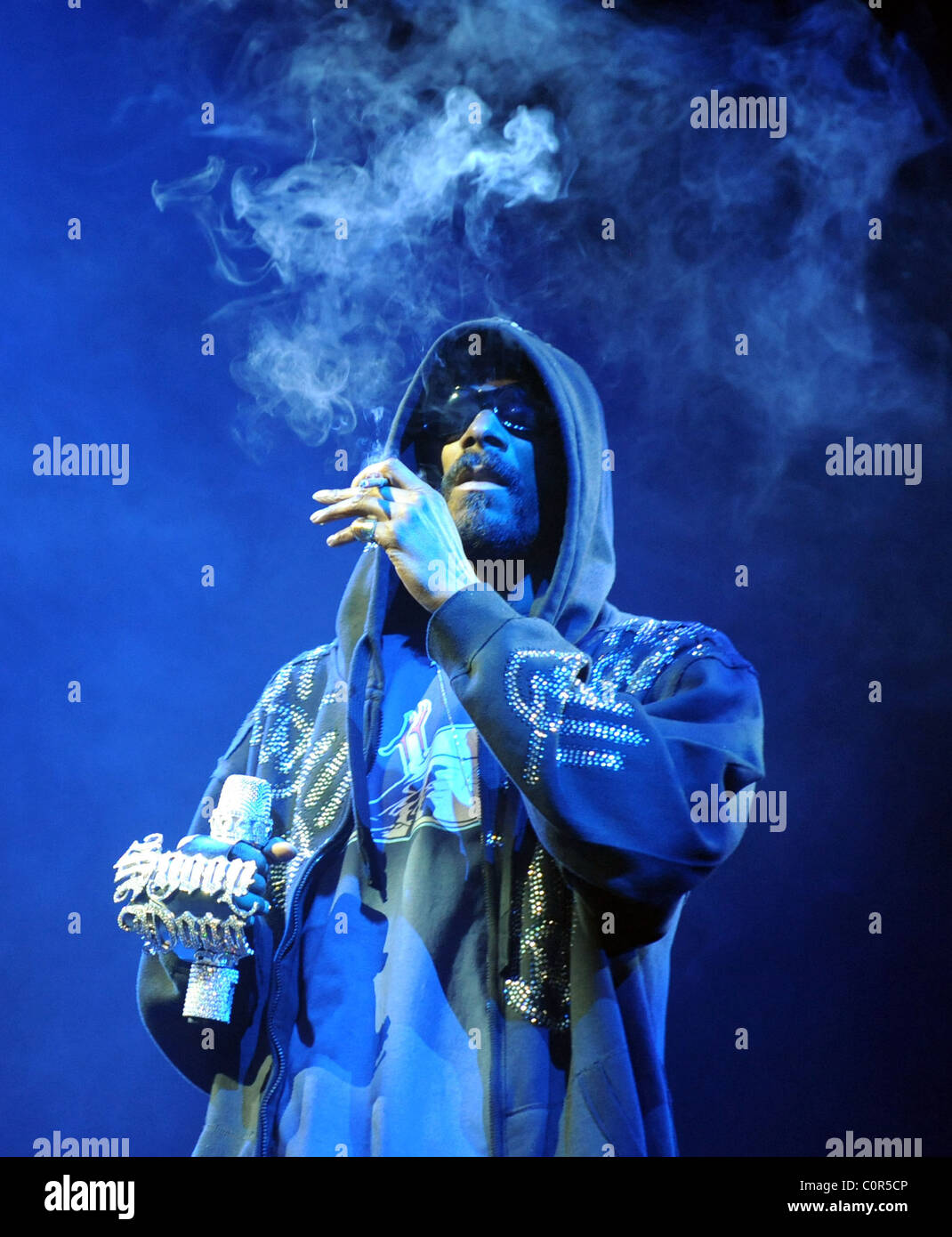 American rapper Snoop Dogg smoking on stage while performing in concert ...