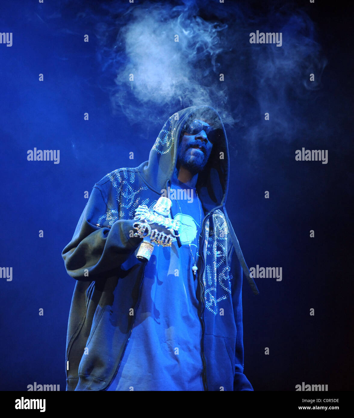 American rapper Snoop Dogg smoking on stage while performing in concert ...