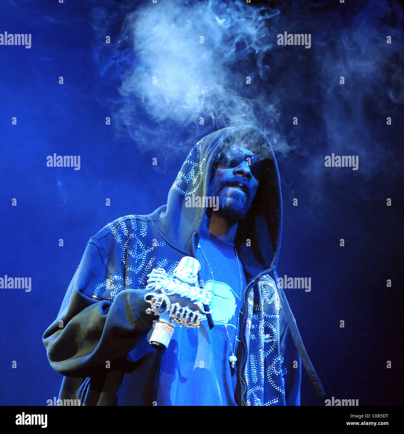 American rapper Snoop Dogg smoking on stage while performing in concert ...