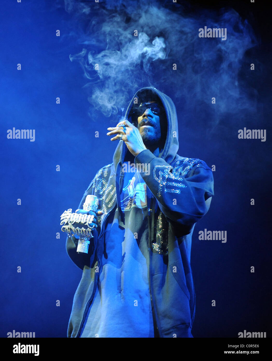 American rapper Snoop Dogg smoking on stage while performing in concert ...