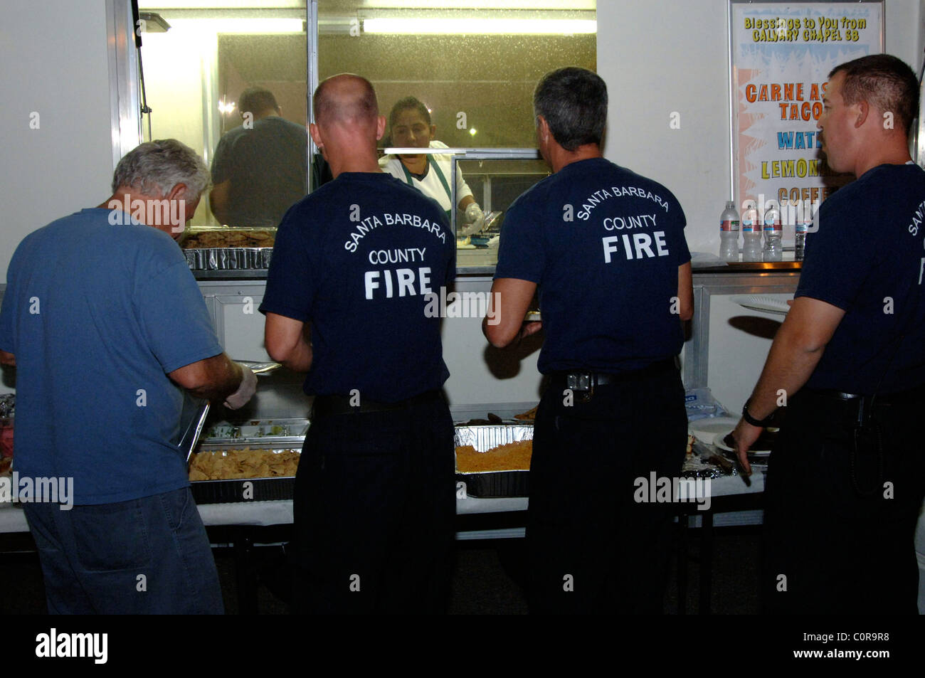 Firefighters and rescue workers eating after working all night ...