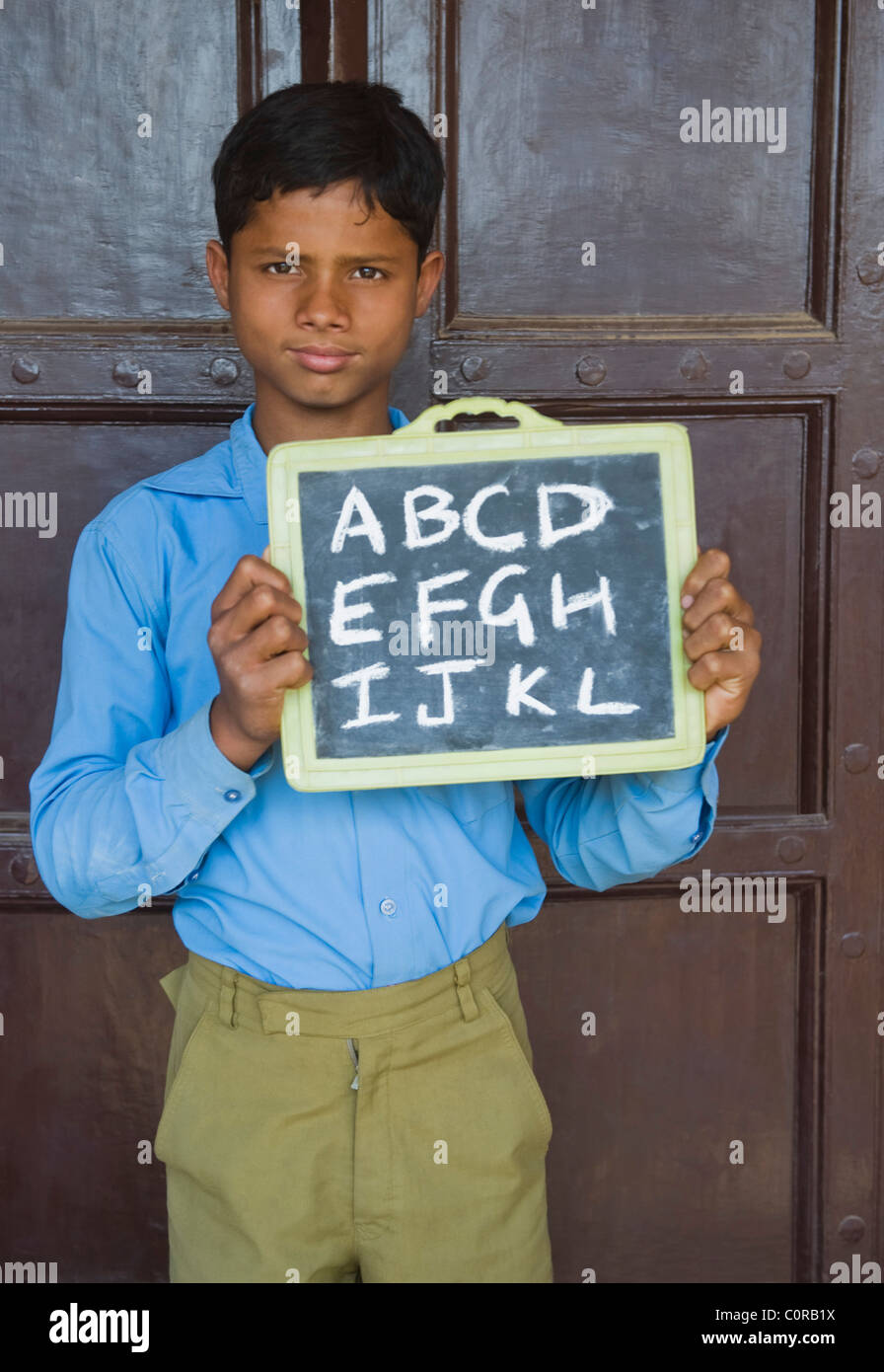 Portrait of a schoolboy holding a slate Stock Photo - Alamy