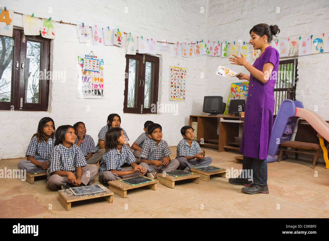 Woman teaching students in a classroom Stock Photo - Alamy